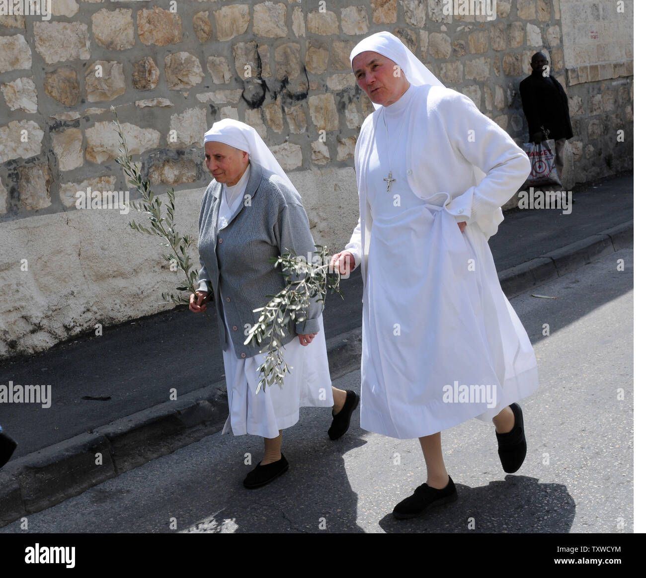 Catholic nuns carry olive branches before the annual Palm Sunday ...