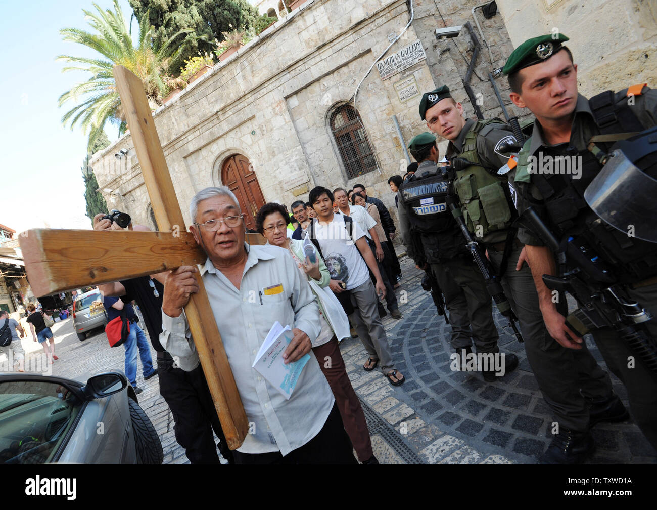 Christian pilgrims carry a cross by Israeli border police on the Via ...