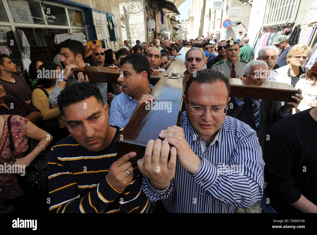 Palestinian Christians carry a cross on the Via Dolorosa, "The Way of ...