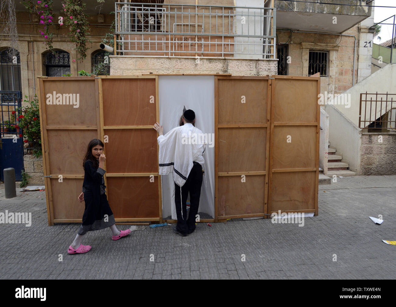 An Ultra-Orthodox Jew looks inside a sukkah, a temporary dwellings ...