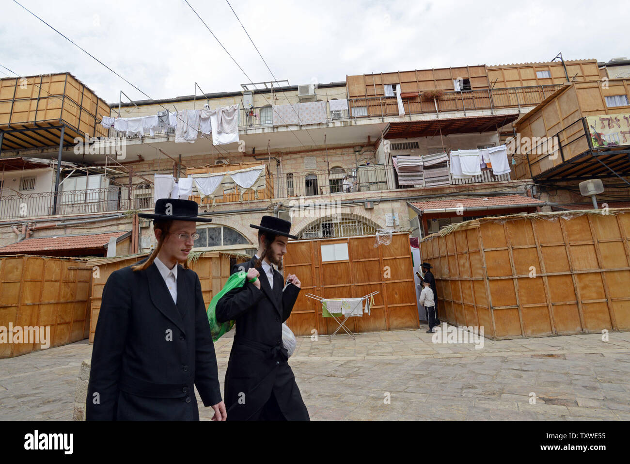 Ultra-Orthodox Jews walk in front of an apartment complex where ...