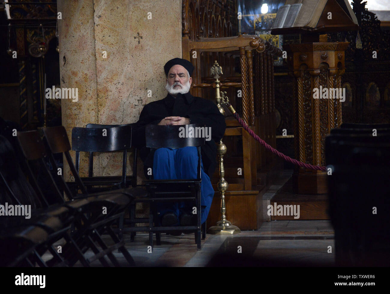 A Greek Orthodox priest sleeps in the Church of Nativity, traditionally ...