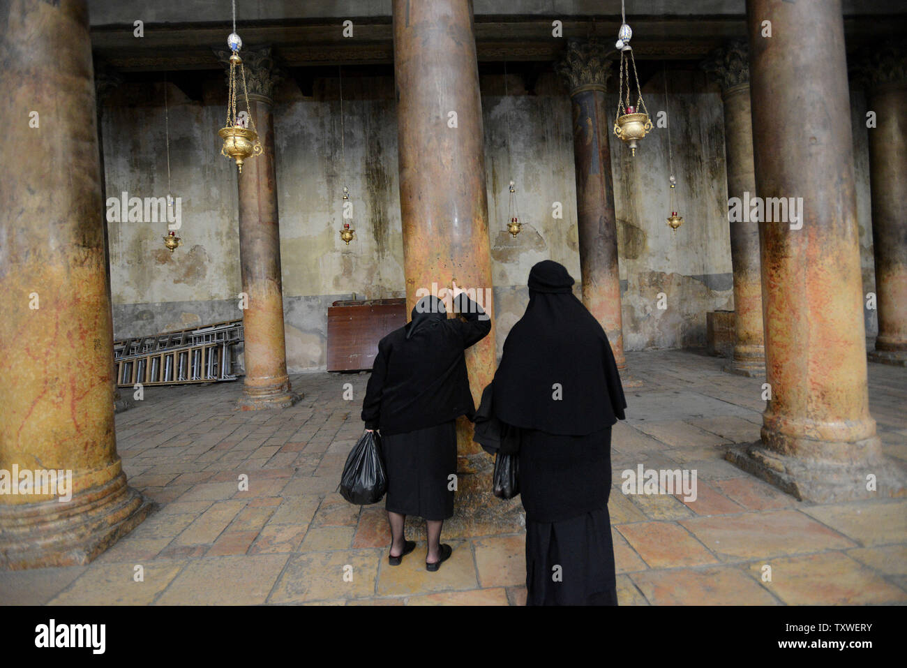 Greek Orthodox Nuns pray in the Church of Nativity, traditionally ...
