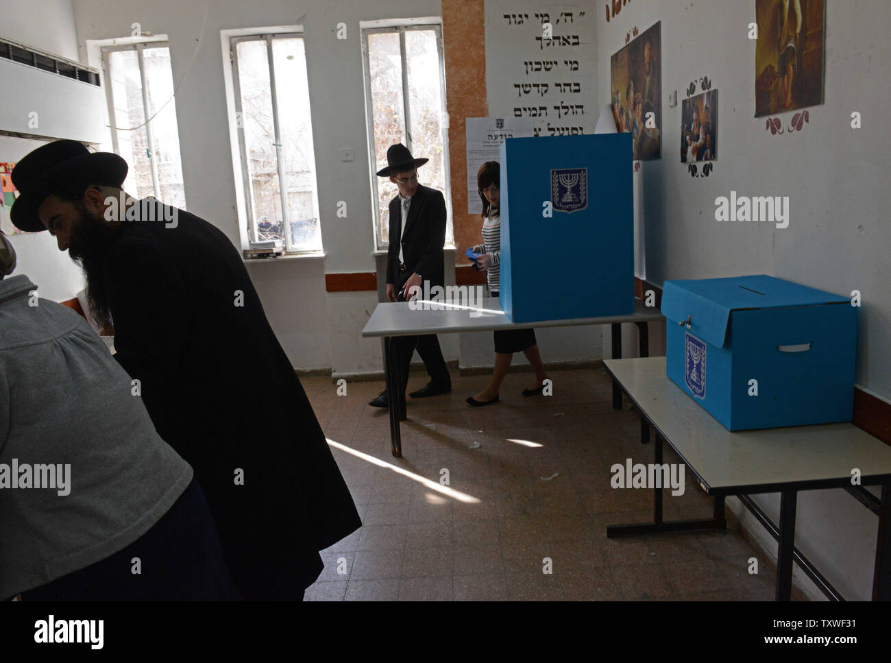 An Ultra-Orthodox Jews vote at a polling station in Mea Shearim ...