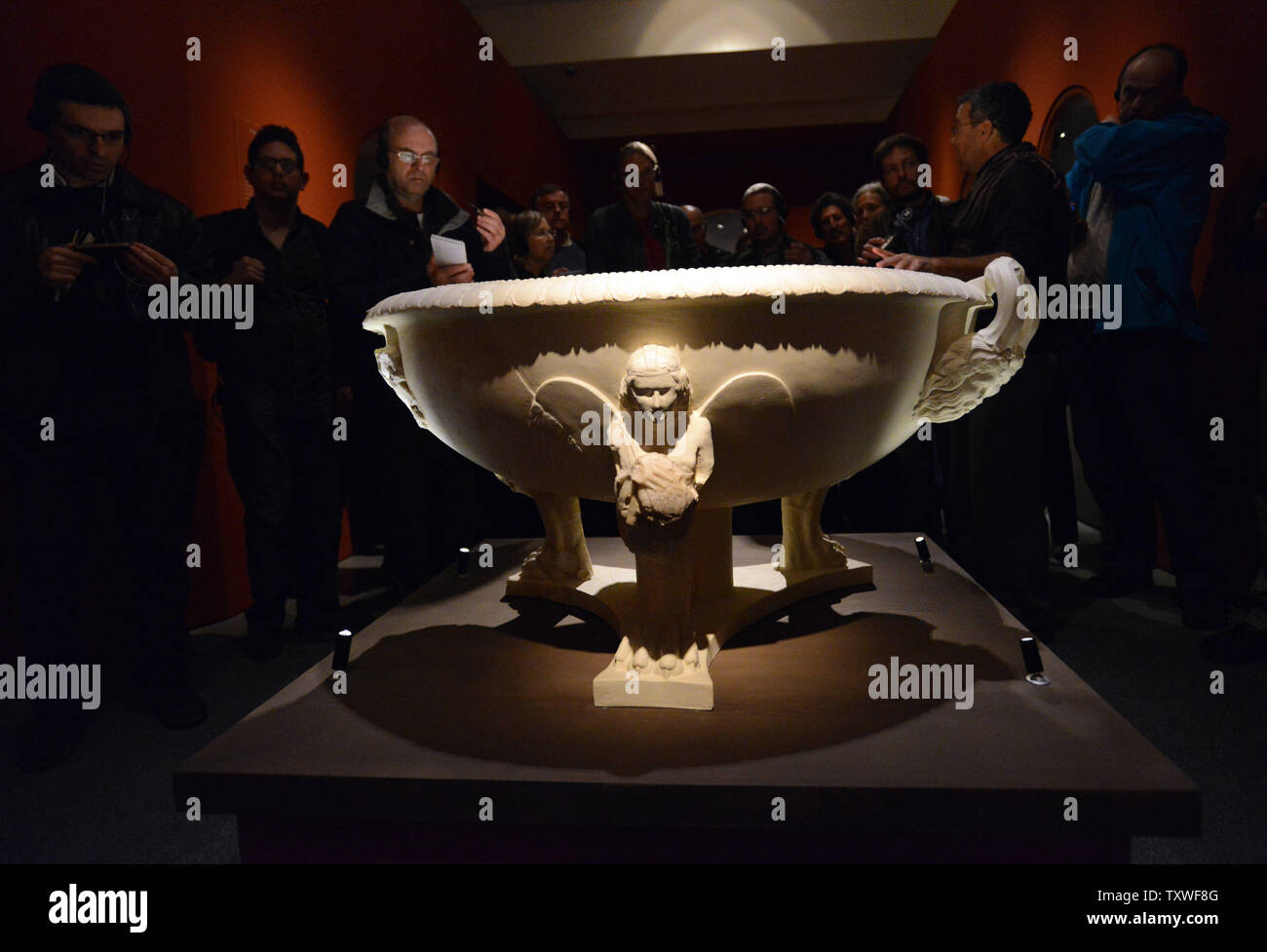 Visitors look at the large marble and plaster basin excavated from the ...