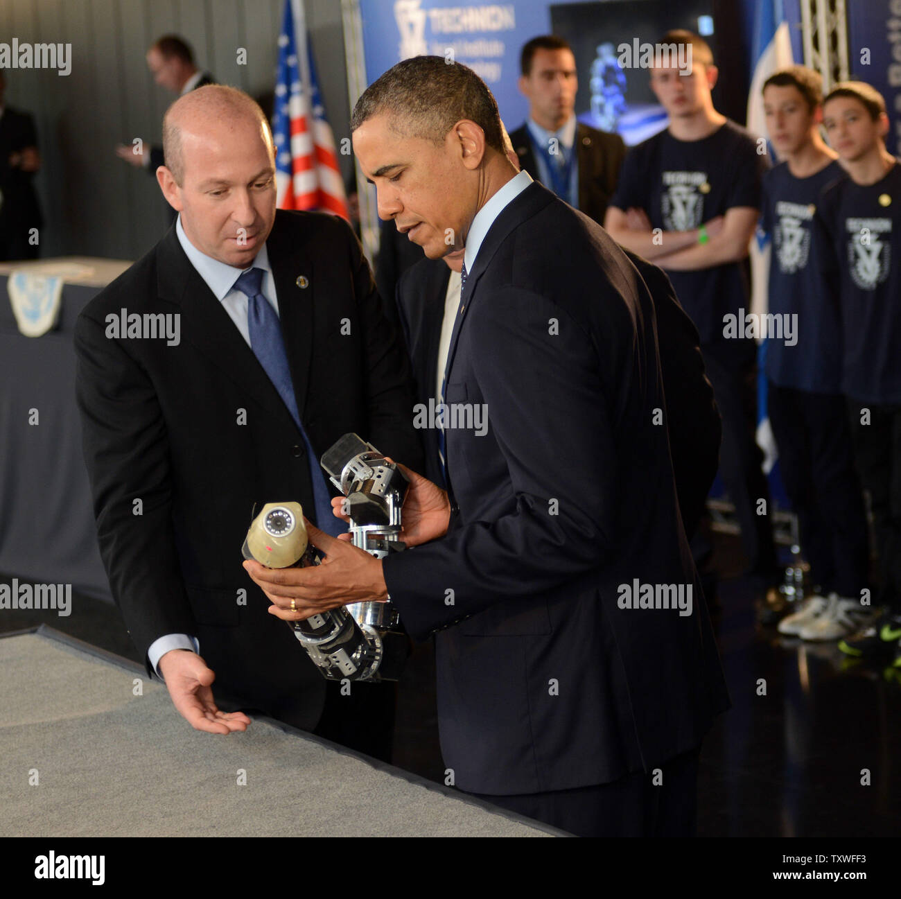 U.S. President Barack Obama holds a robotic snake used in search and ...