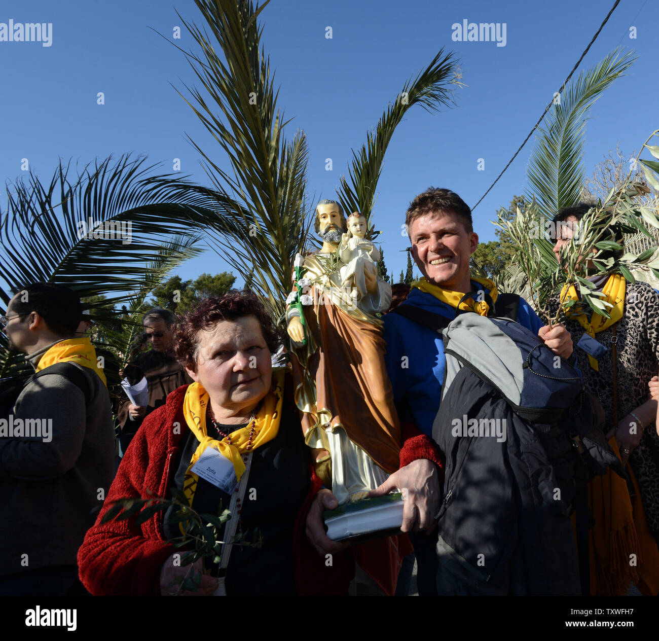 Christians carry palm branches and a statue of Jesus Christ during the ...