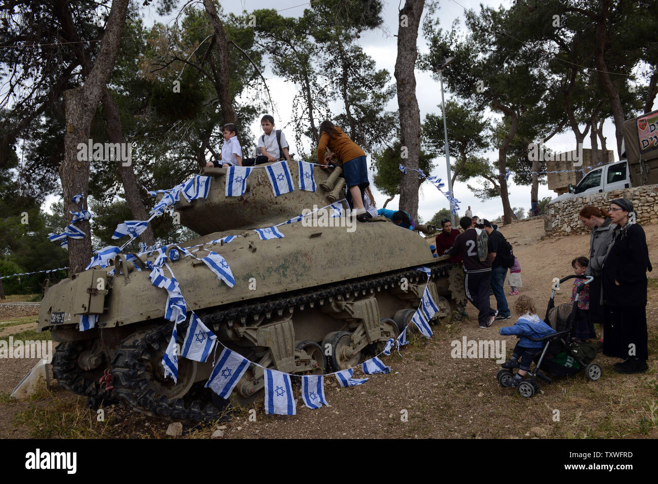Israeli children play on an old military tank on Ammunition Hill in ...