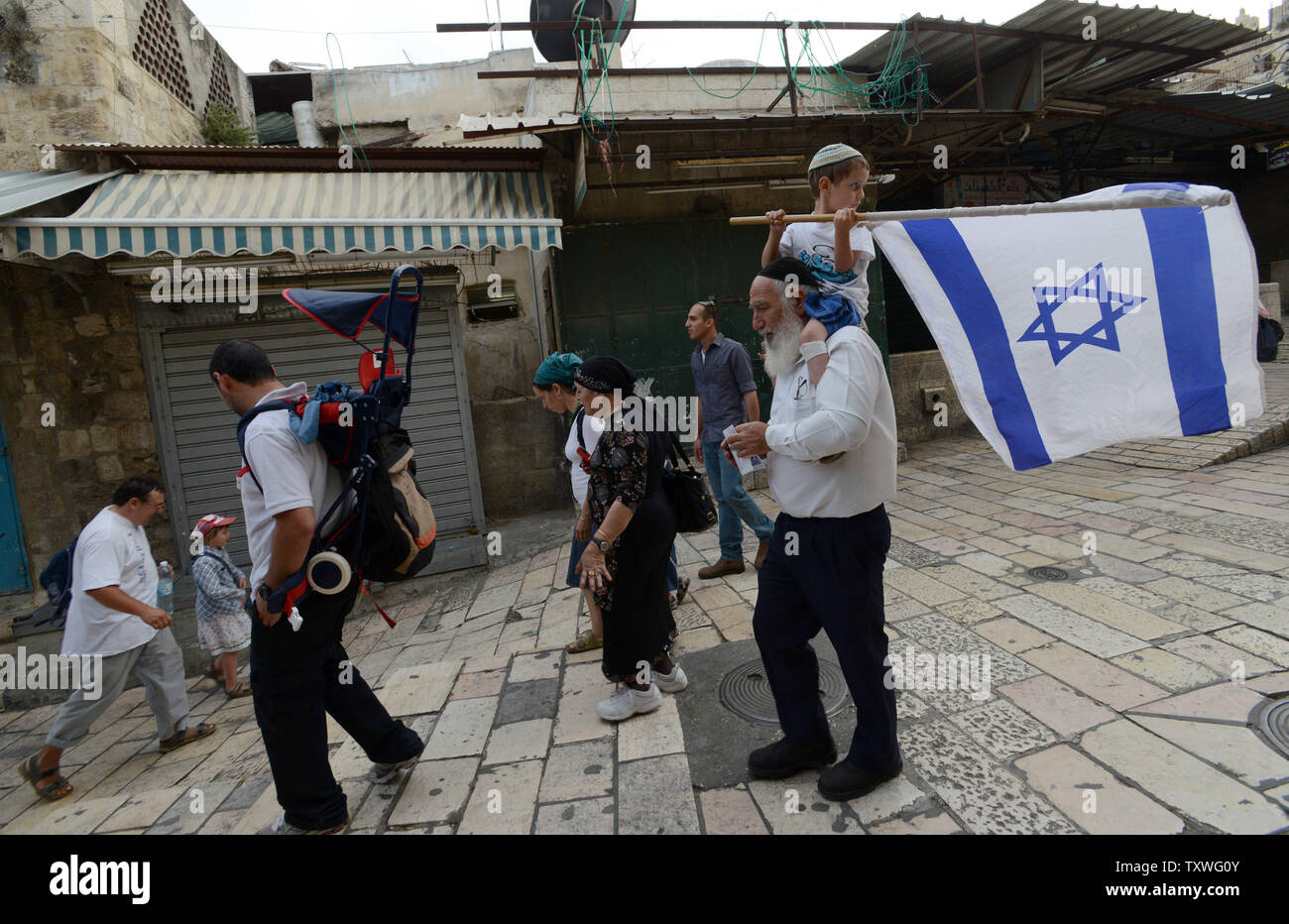An Israeli boy carries the national flag during the traditional Flag ...