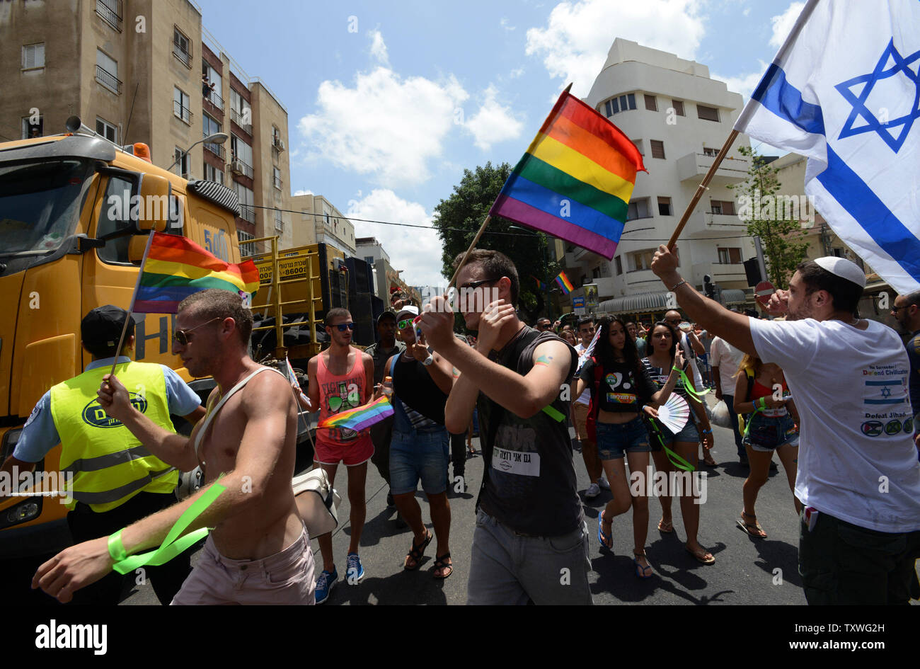 Participants wave rainbow and an Israeli flags during the annual Gay ...