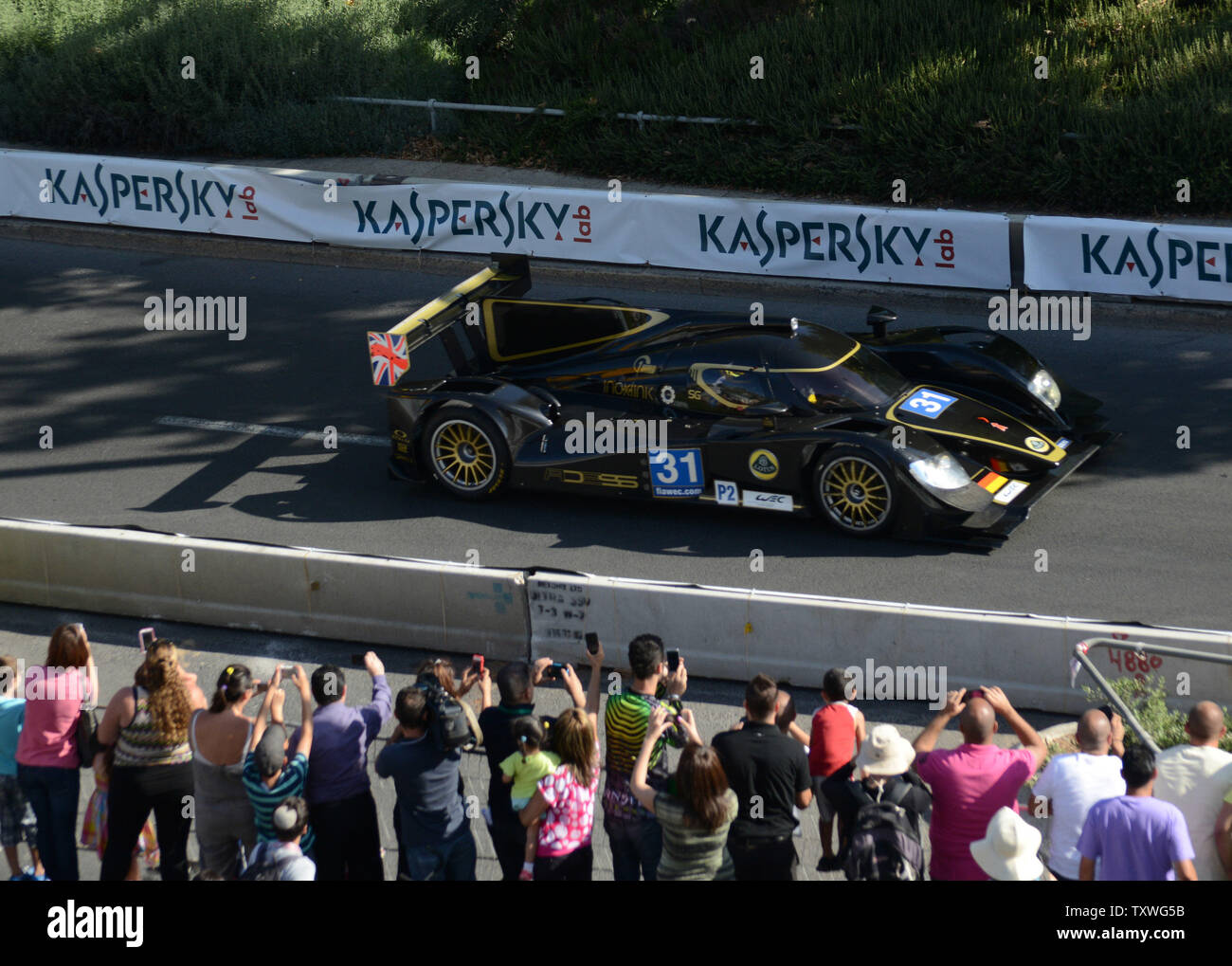 A Ferrari Formula One race car speeds past Israeli spectators during ...