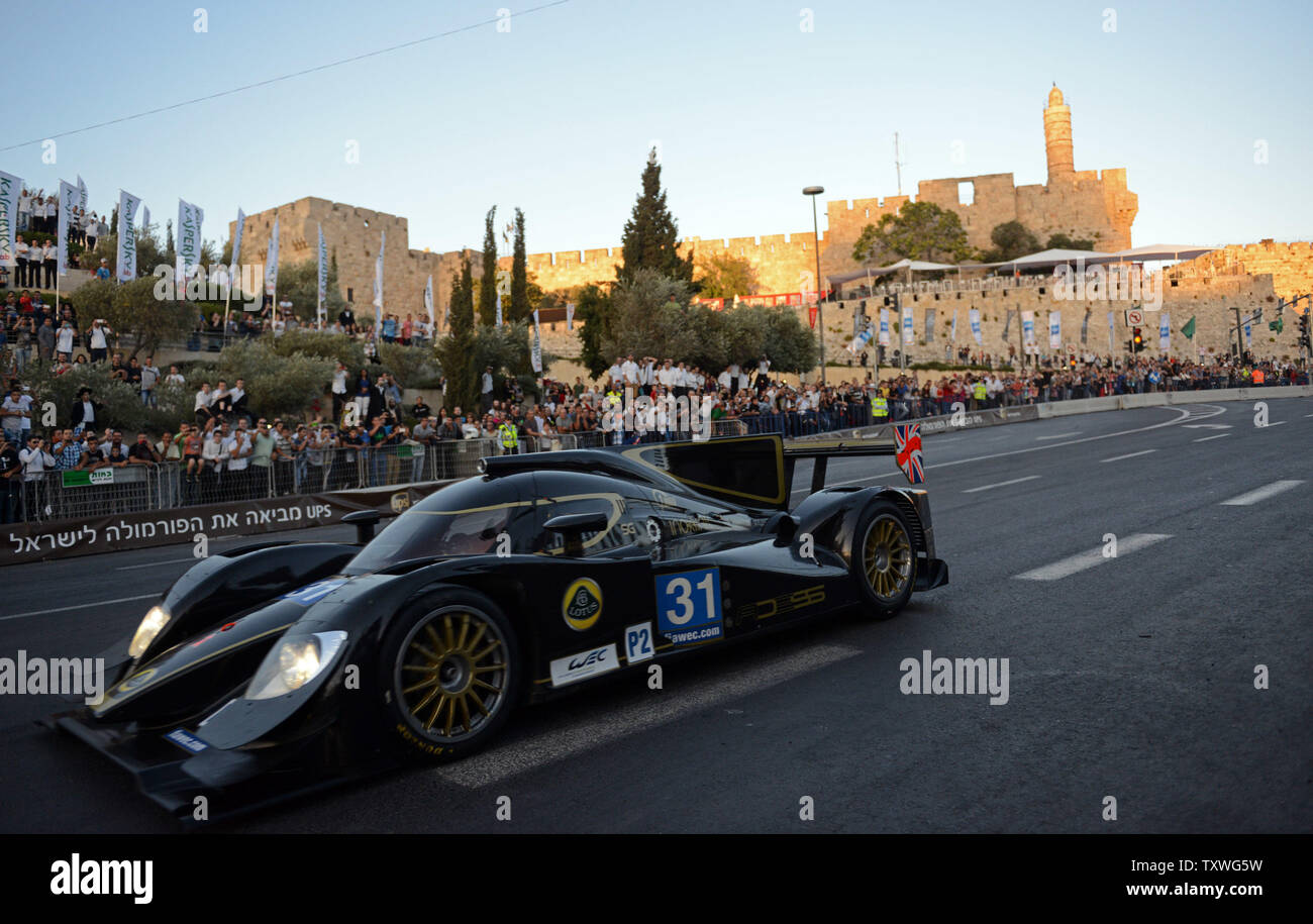 A Ferrari Formula One race car speeds past Israeli spectators below the ...