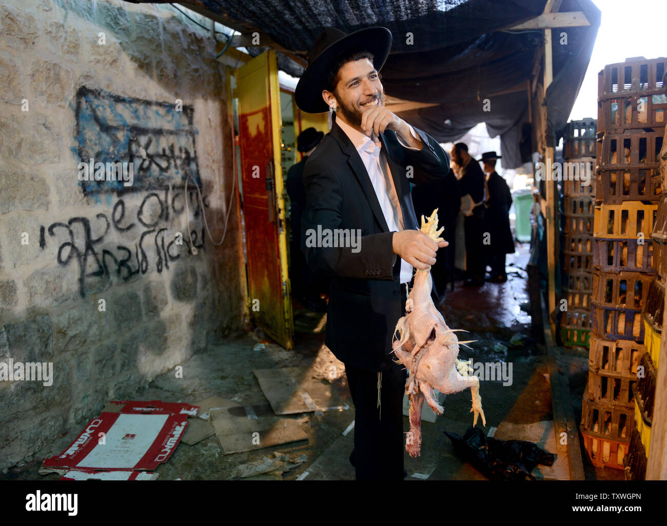 An Ultra Orthodox Jew holds a dead chicken that was used to perform the ...