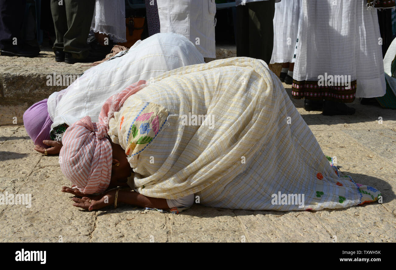 Ethiopian Jewish women kneel to pray during the Sigd holiday on a hill ...