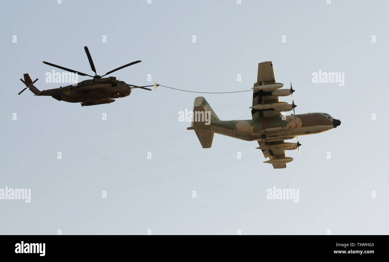 An Israeli Air Force C130 Hercules plane refuels a Sikorsky helicopter ...