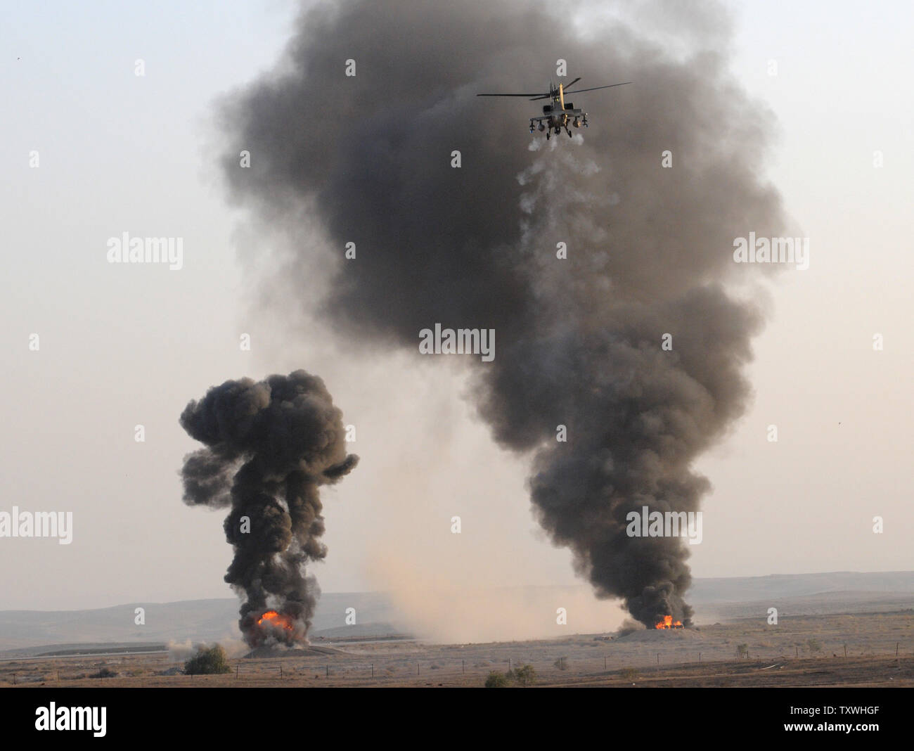 An Israeli Air Force Apache helicopter performs during an air show at ...