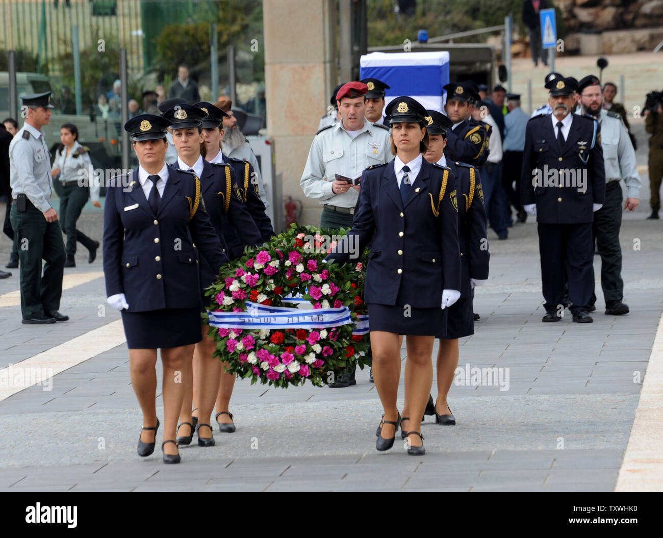 Members of the Knesset guard carry wreaths in front of the coffin of ...
