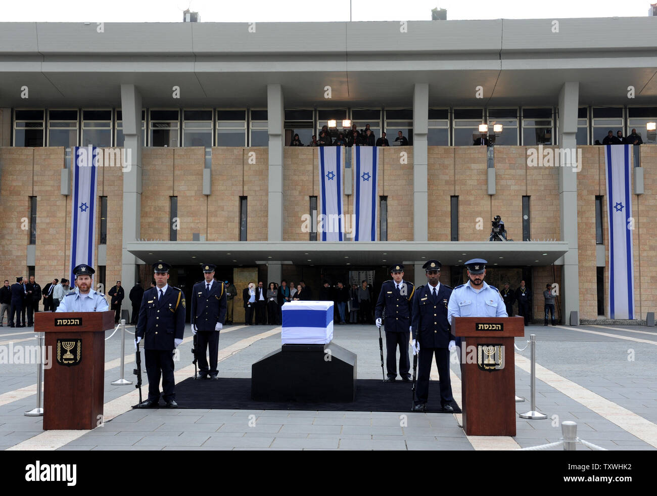 Members of the Knesset guard stand beside the coffin of the late former ...