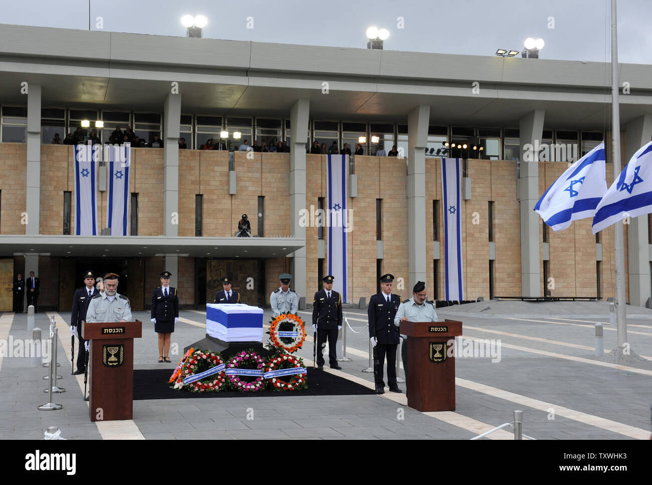 Members of the Knesset guard stand beside the coffin of the late former ...