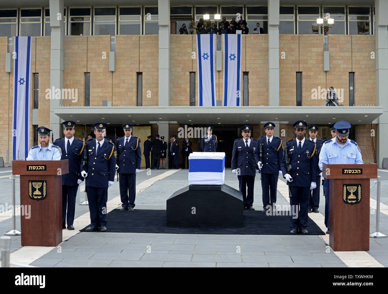 Members of the Knesset guard stand beside the coffin of the late former ...