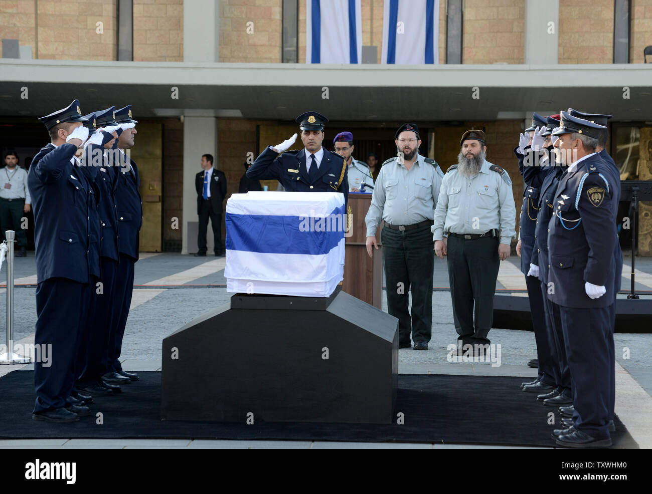 Members of the Knesset guard salute the coffin of the late former ...