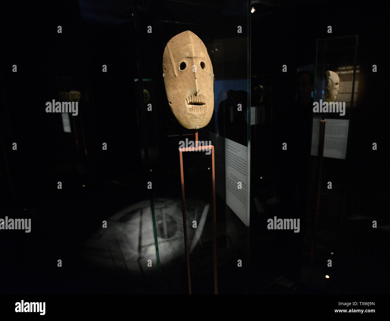 A mask from the Neolithic period ( 9,000 years ago) is displayed in the ...