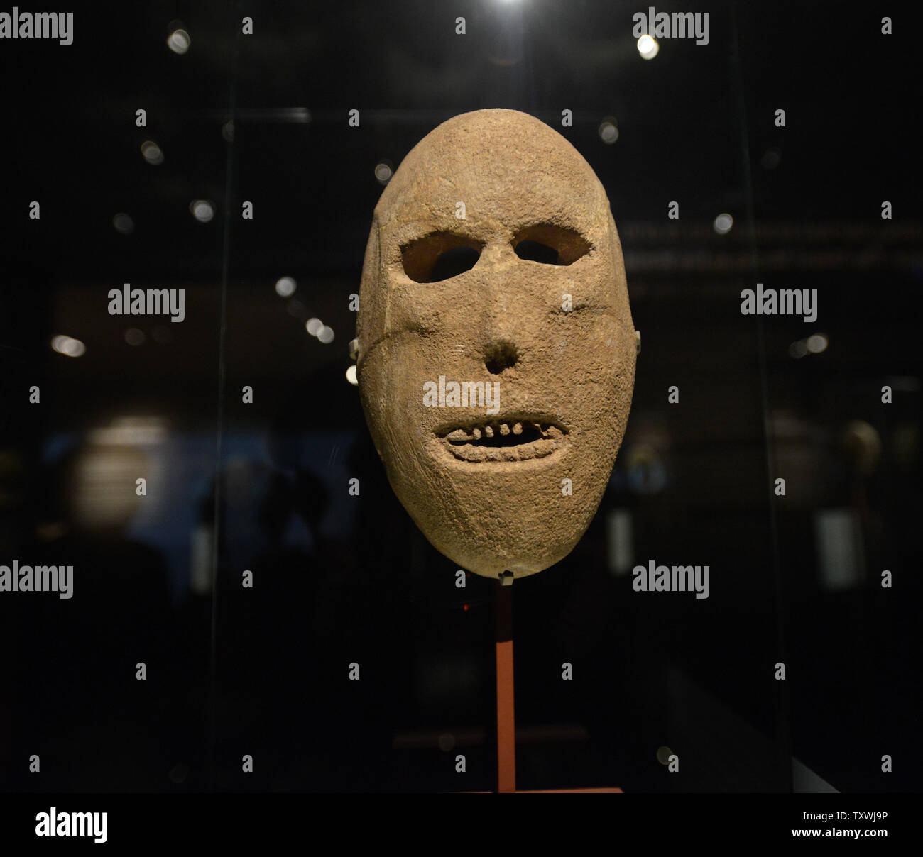 A mask from the Neolithic period ( 9,000 years ago) is displayed in the ...