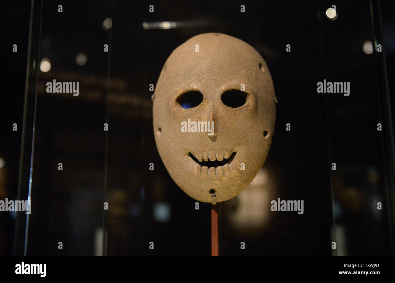 A mask from the Neolithic period ( 9,000 years ago) is displayed in the ...