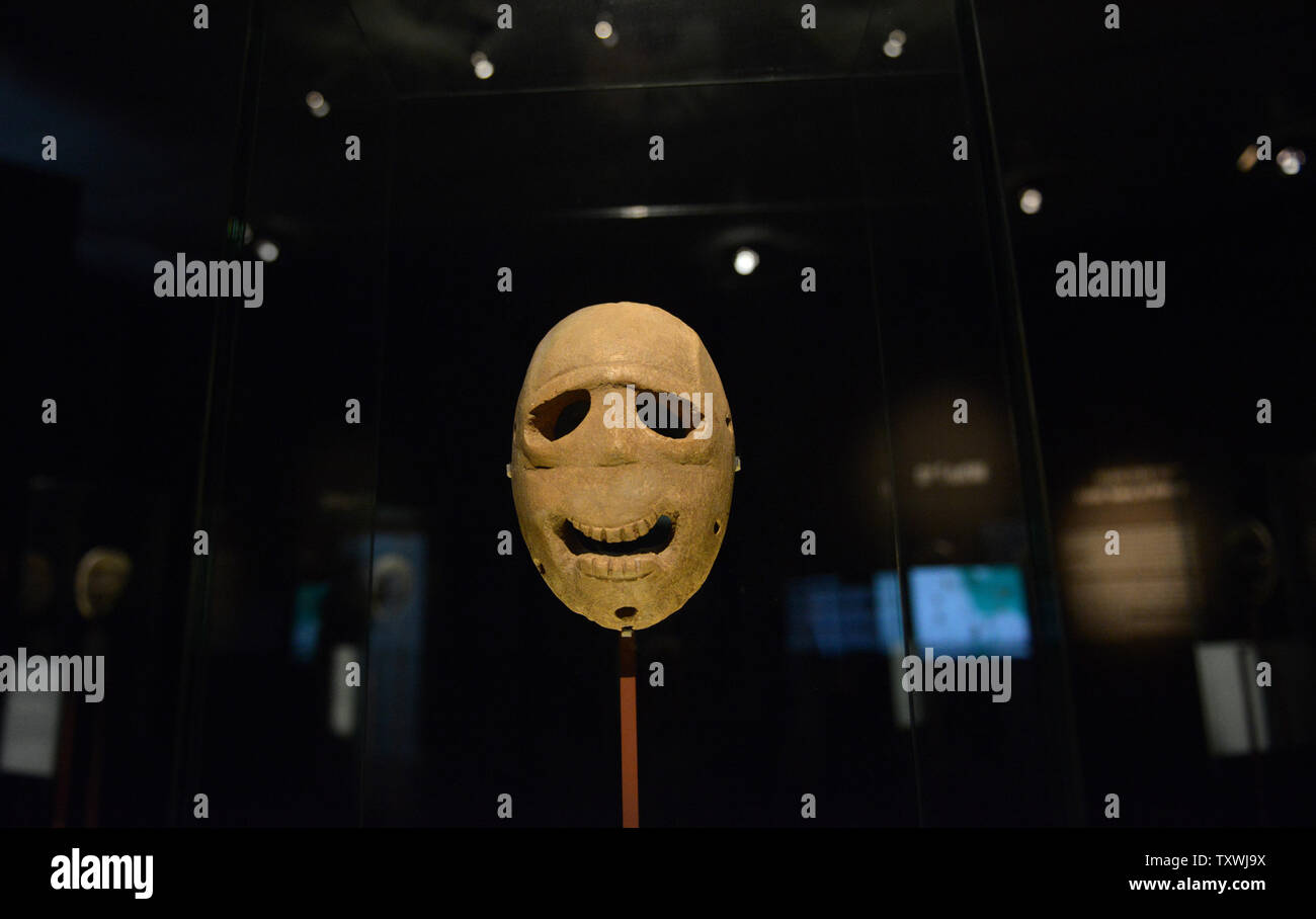 A mask from the Neolithic period ( 9,000 years ago) is displayed in the ...