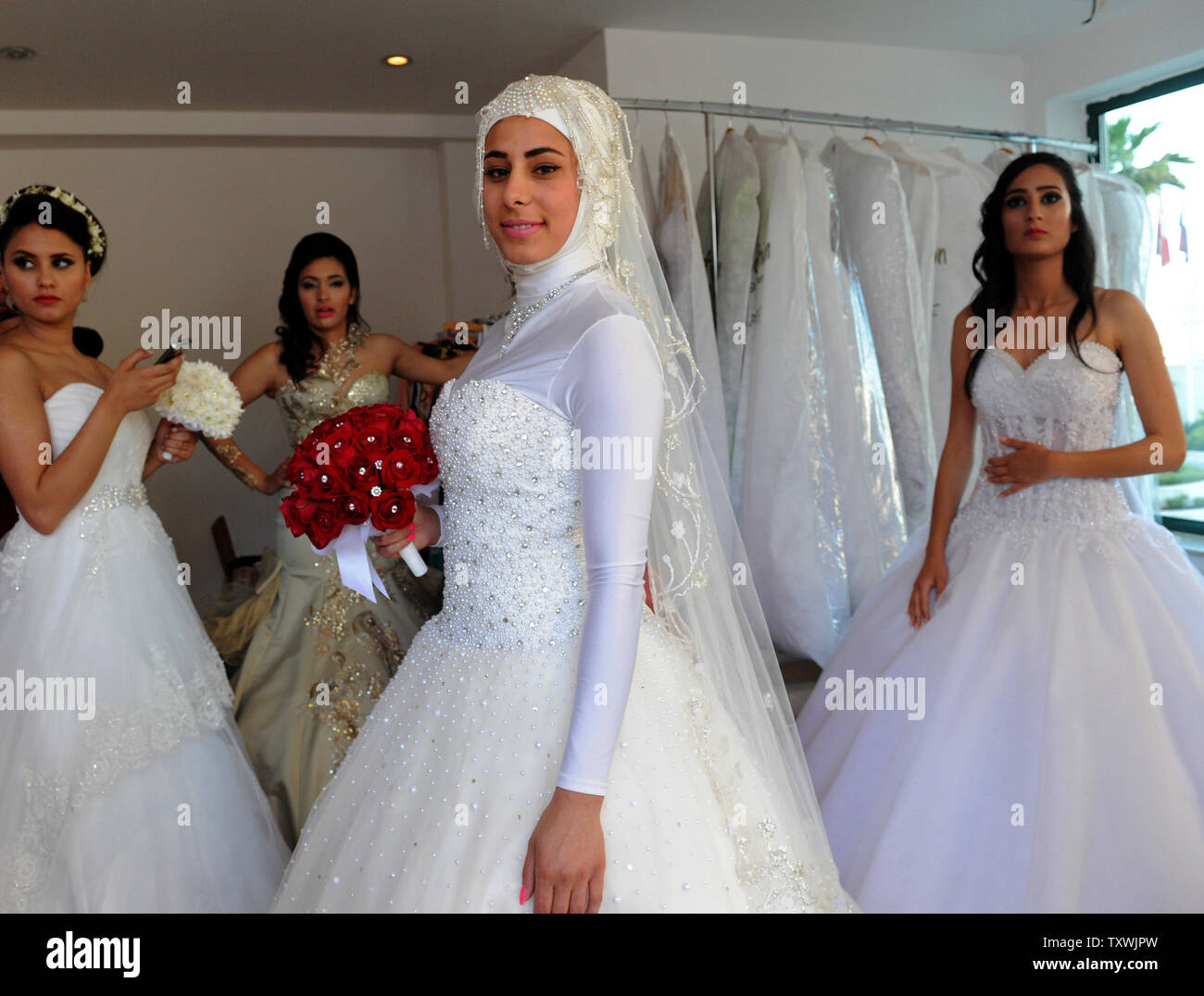 Palestinian models wait to walk the runway at the opening ceremony of the Palestine Fashion Week ...