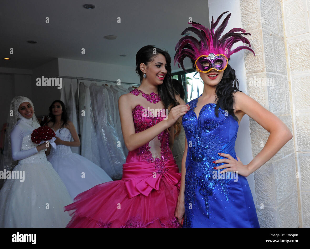 A Palestinian model wears a mask before walking the runway at the ...