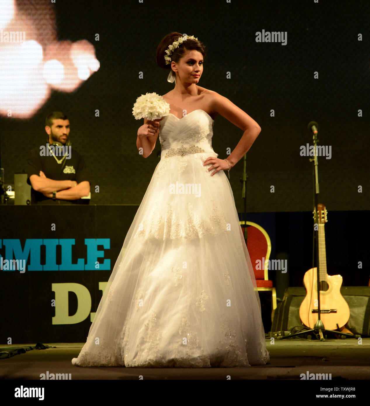 A Palestinian model wears a bridal gown on the runway at the opening ...