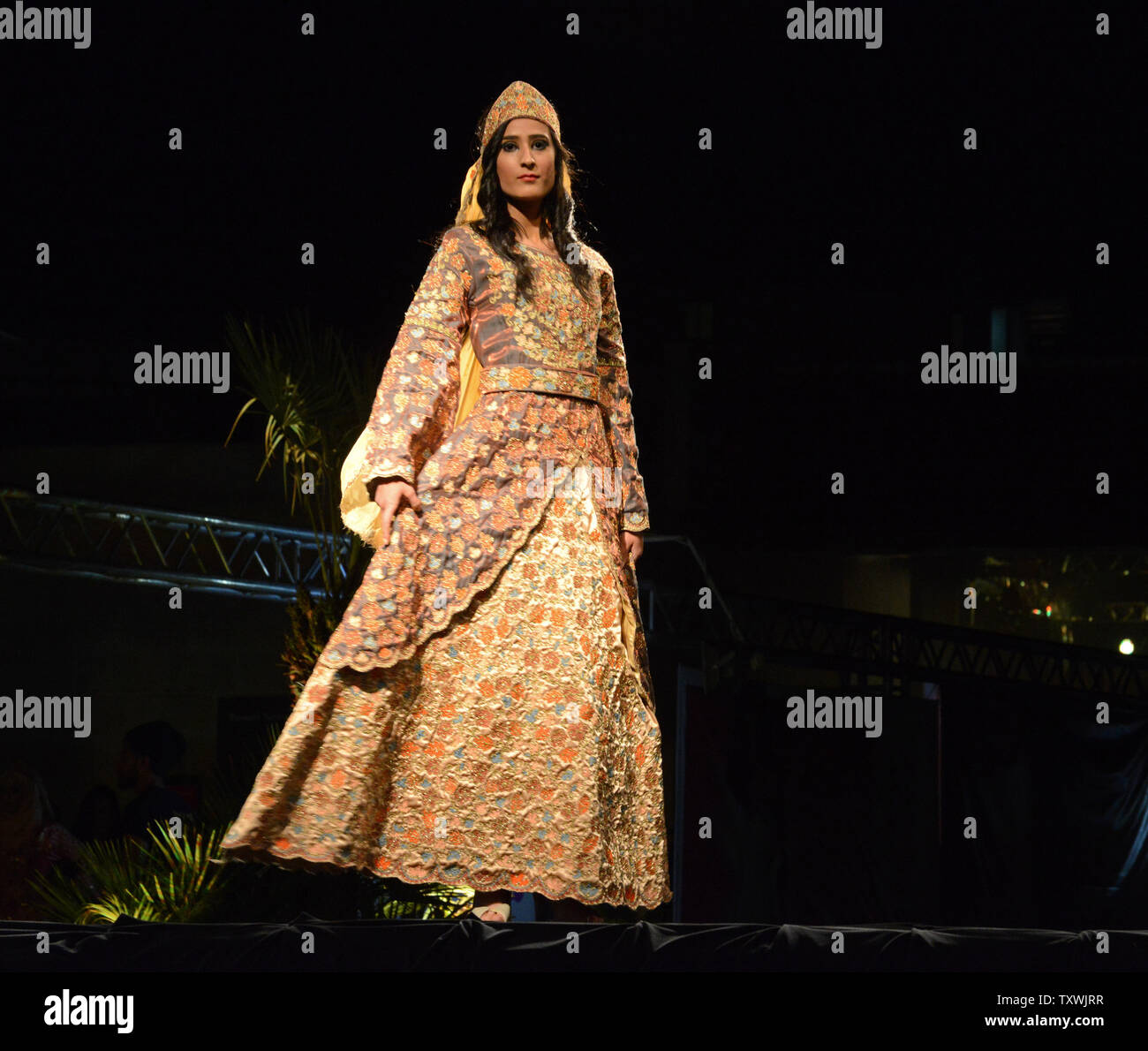 A Palestinian model wears a traditional dress by Palestinian designer ...