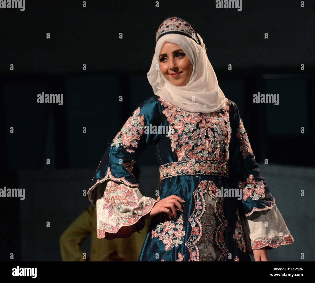 A Palestinian model wears a traditional dress by Palestinian designer Um Abdullah Abzrieh, on ...