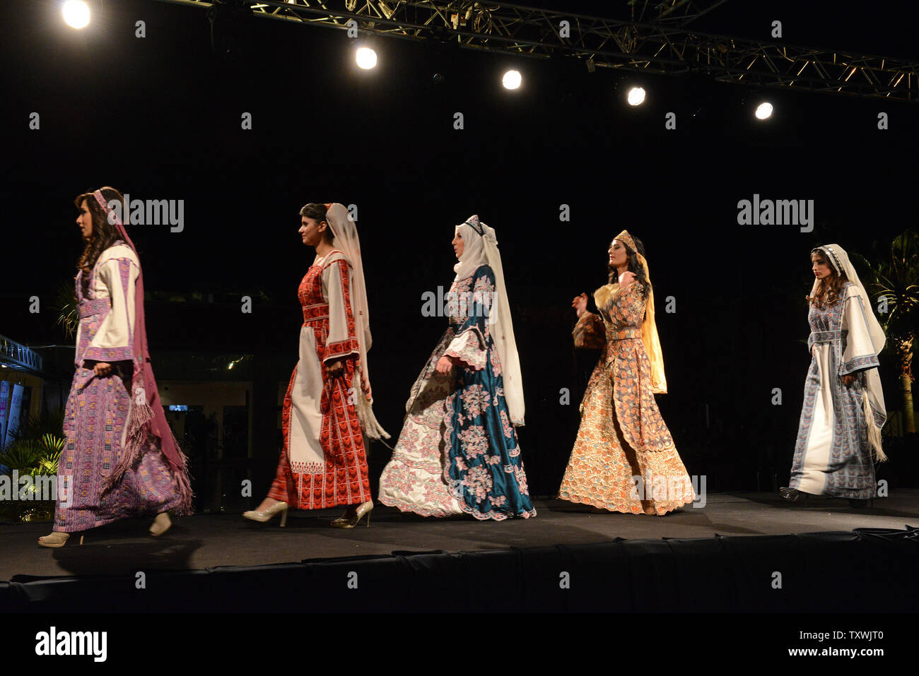 Palestinian models wear traditional dresses by Palestinian designer Um ...