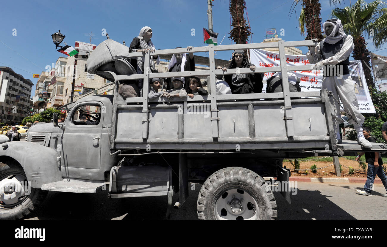 Palestinian actors reenact the displacement of Palestinians during the ...