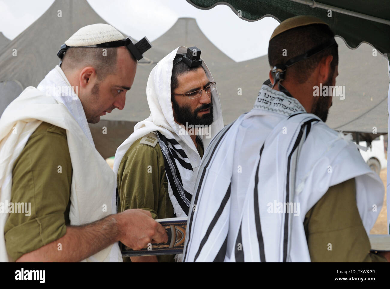 Israeli soldiers wear the traditional Jewish prayer shawl during ...
