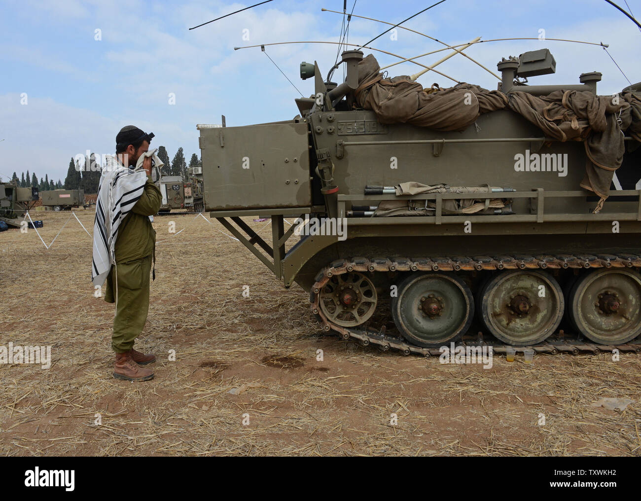 An Israeli soldier wears the traditional Jewish prayer shawl during ...