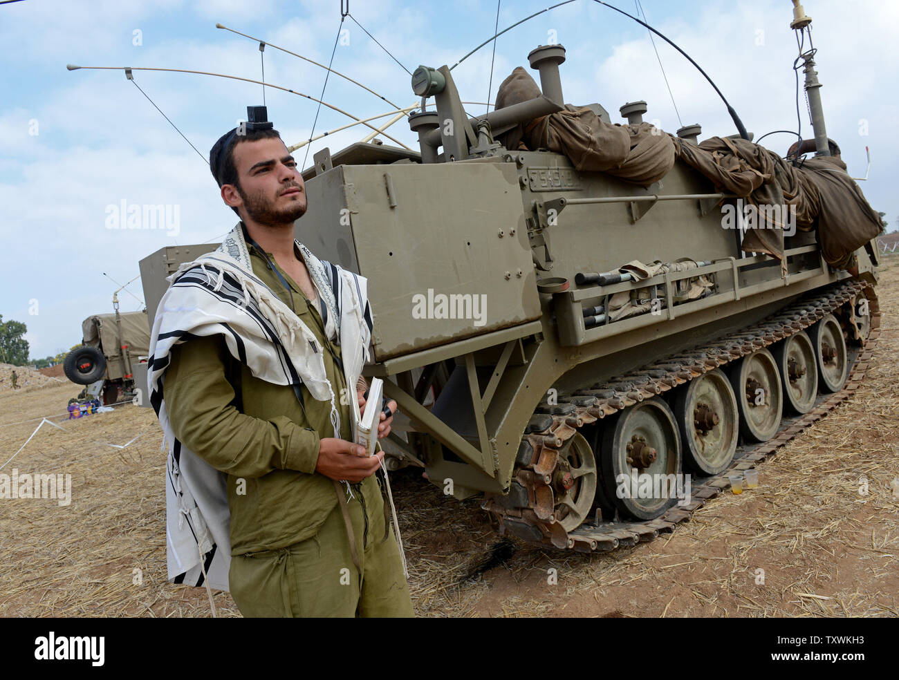 An Israeli soldier wears the traditional Jewish prayer shawl during ...