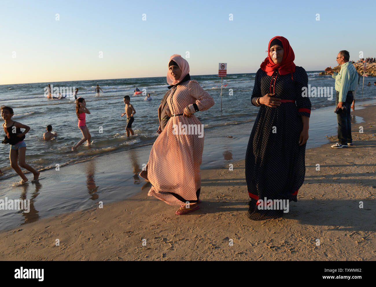 Palestinian Muslims enjoy the Mediterranean Sea in Tel Aviv, Israel, on ...