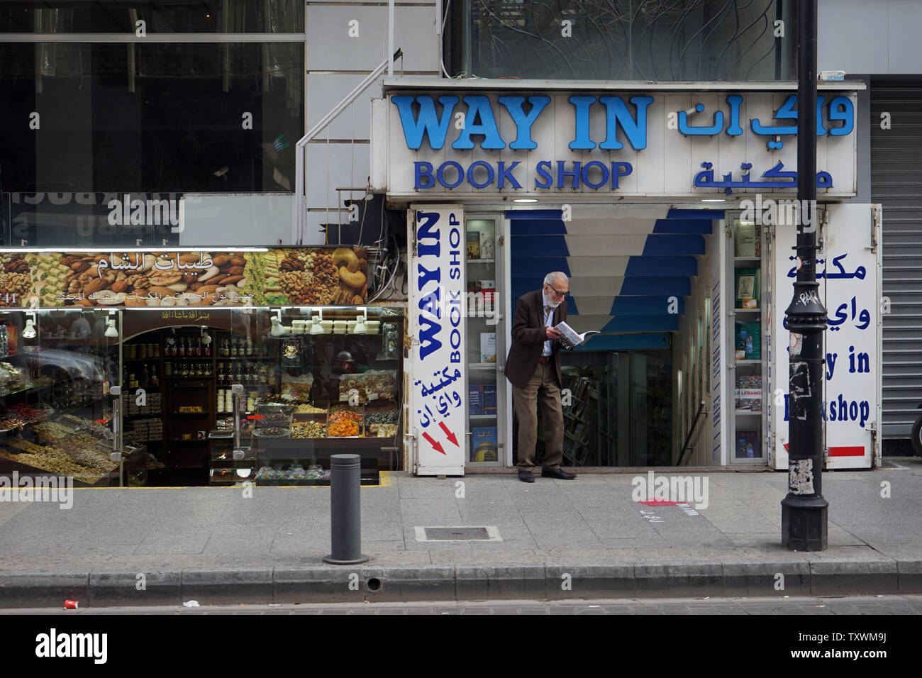 BEIRUT, LEBANON - CIRCA APRIL 2019 Man with magazine and book shop ...