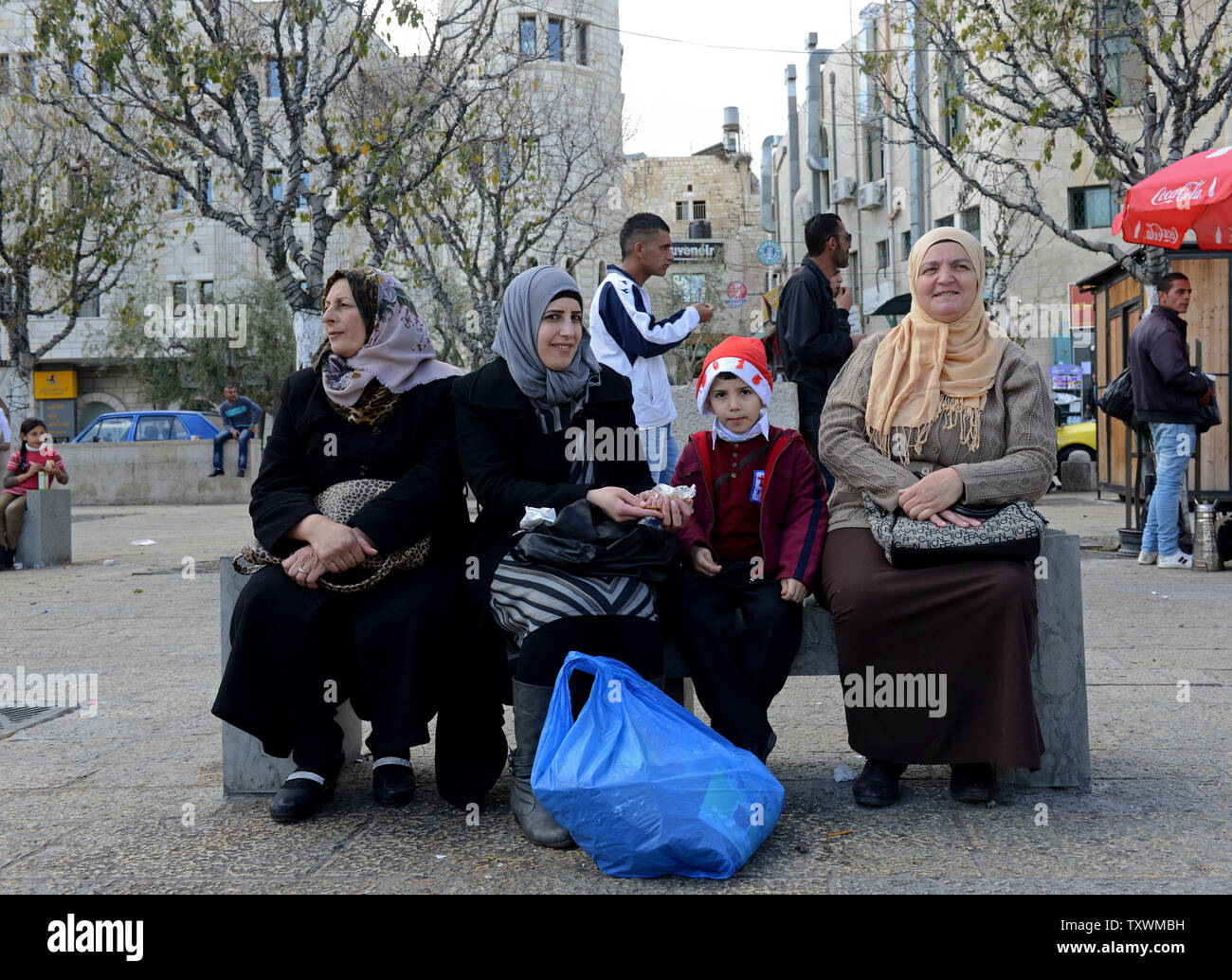 A Palestinian boy wears a Santa Claus hat in Manger Square outside the ...