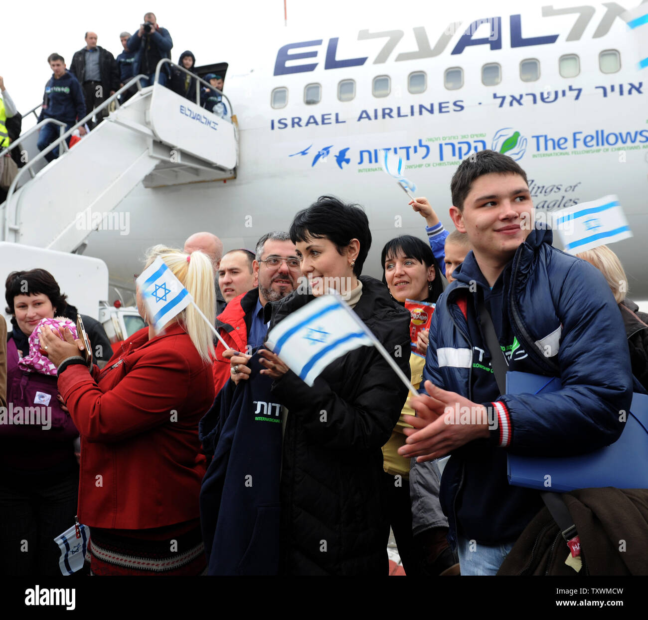 Jews from the Ukraine wave Israeli flags at Ben Gurion Airport, near ...