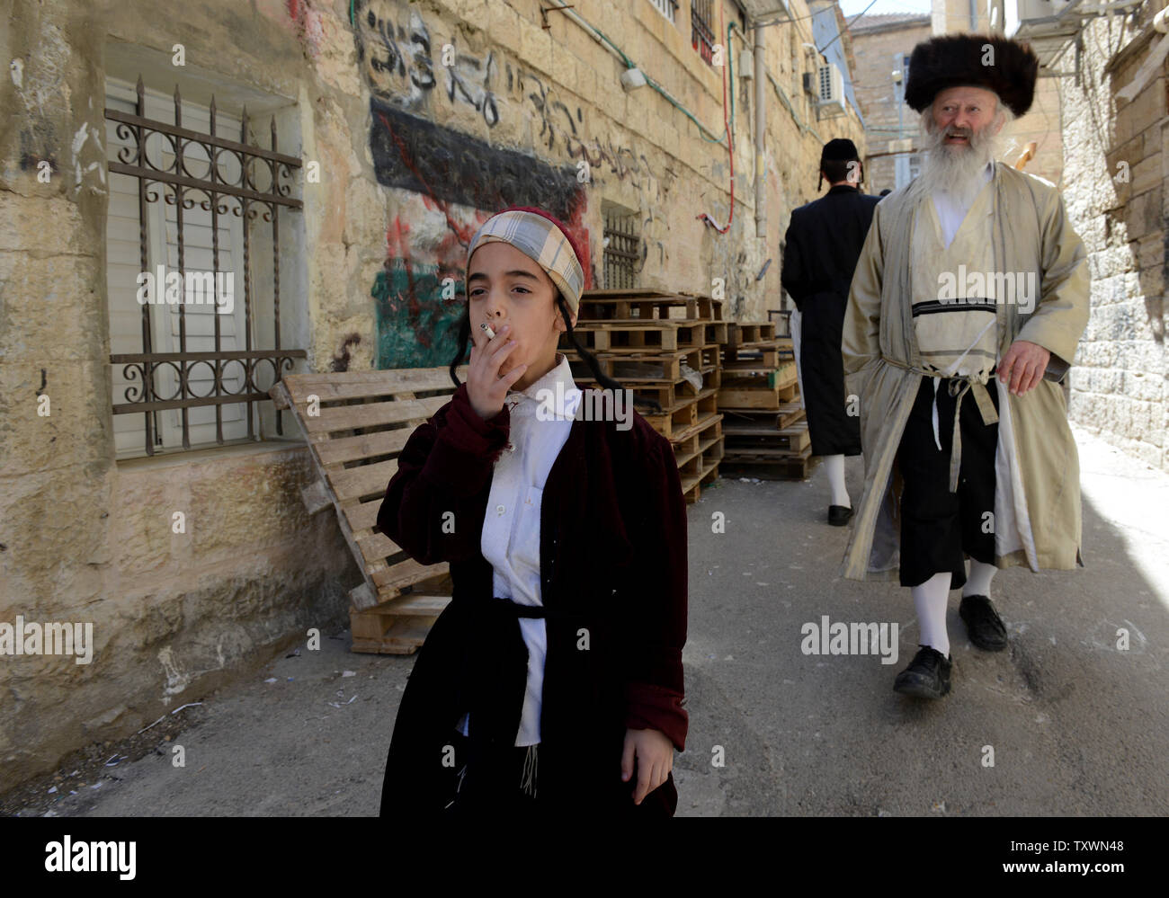 An Ultra-Orthodox Jewish boy wears a costume and smokes a cigarette on ...
