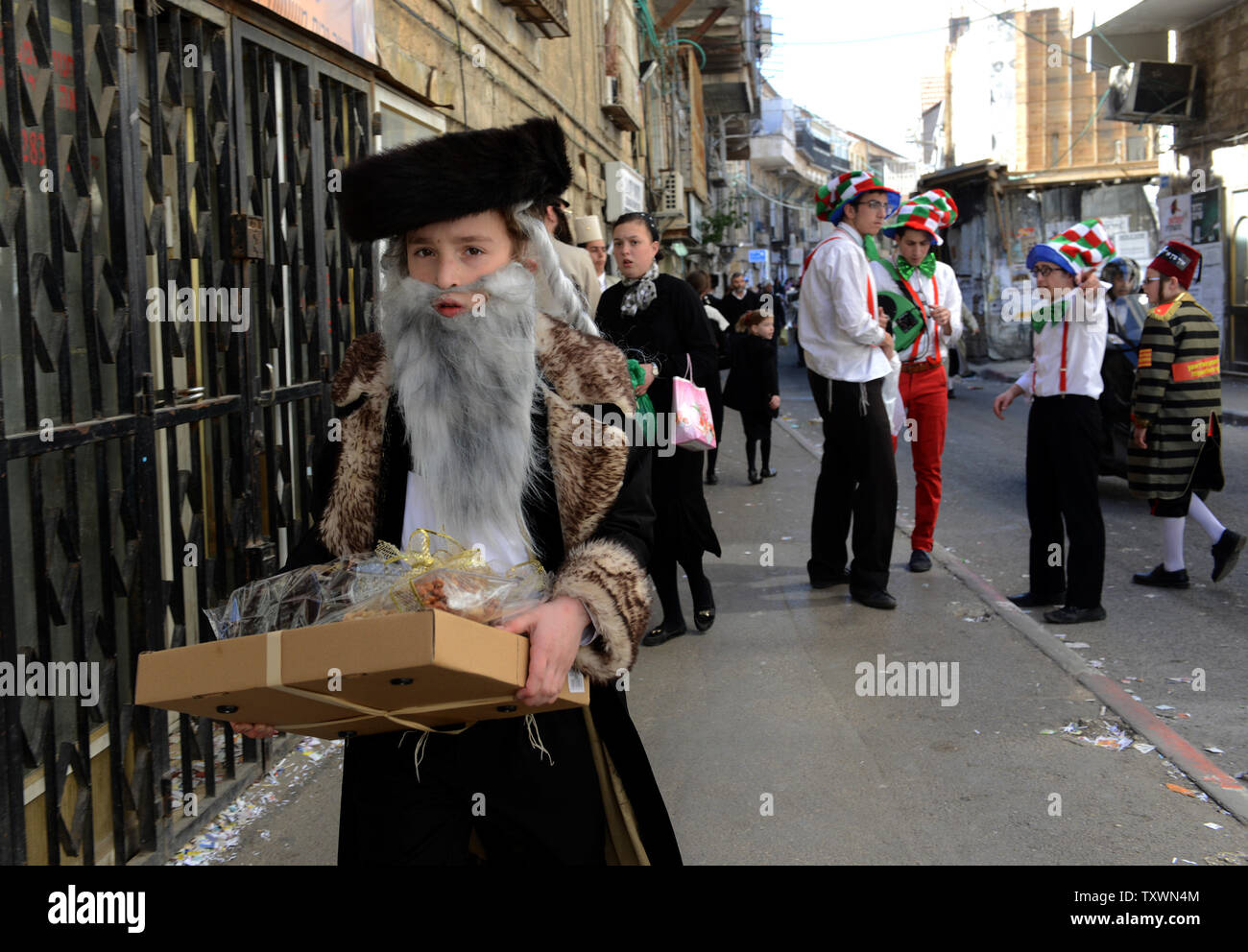 An Ultra-Orthodox Jewish boy wears a costume and smokes a cigarette on ...