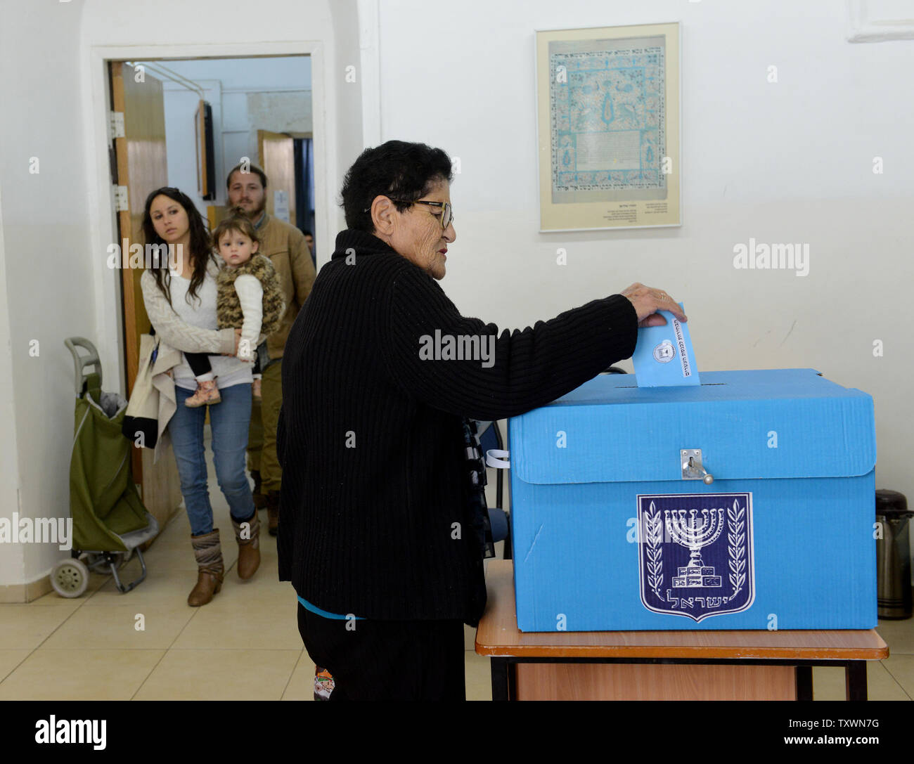 An Israeli casts her vote in a polling station in central Jerusalem ...