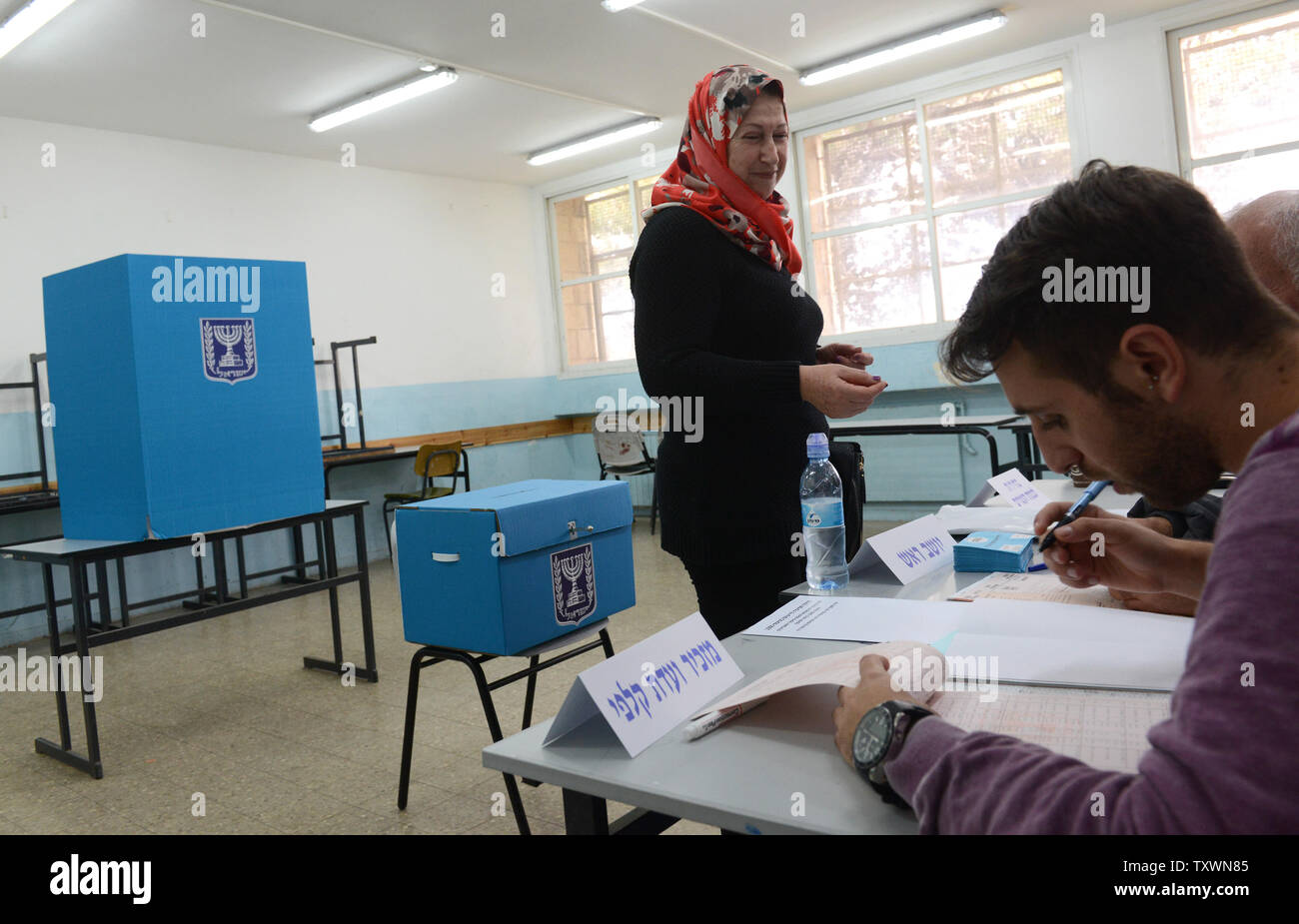 An Arab Israeli waits to vote at a polling station in the Beit Safafa ...