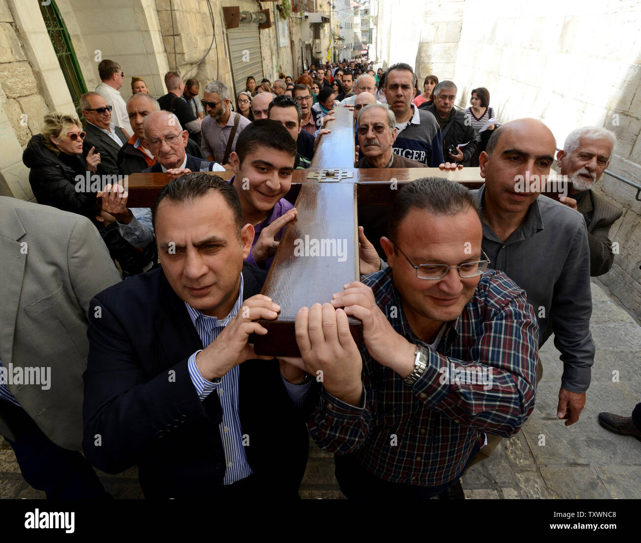 Palestinians carry a cross on Good Friday on the Via Dolorosa, the path ...