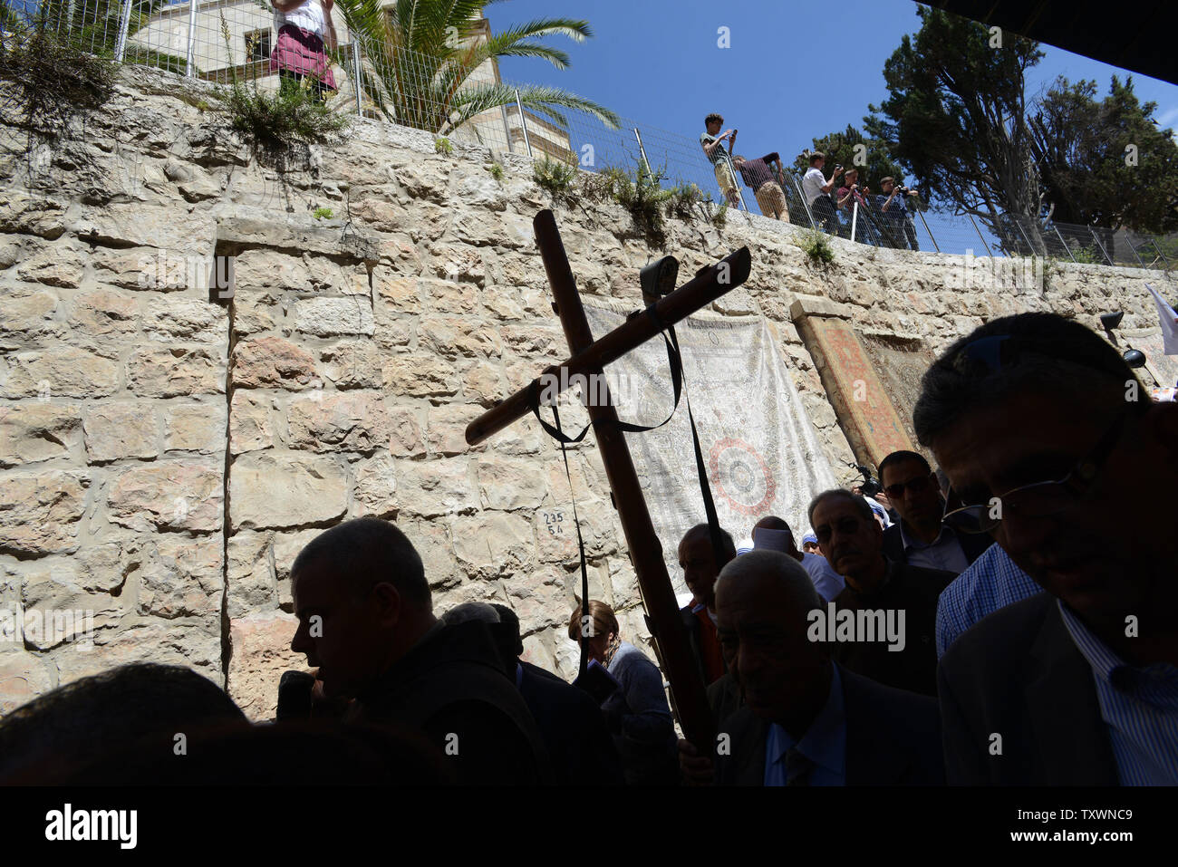 Palestinians carry a cross on Good Friday on the Via Dolorosa, the path ...