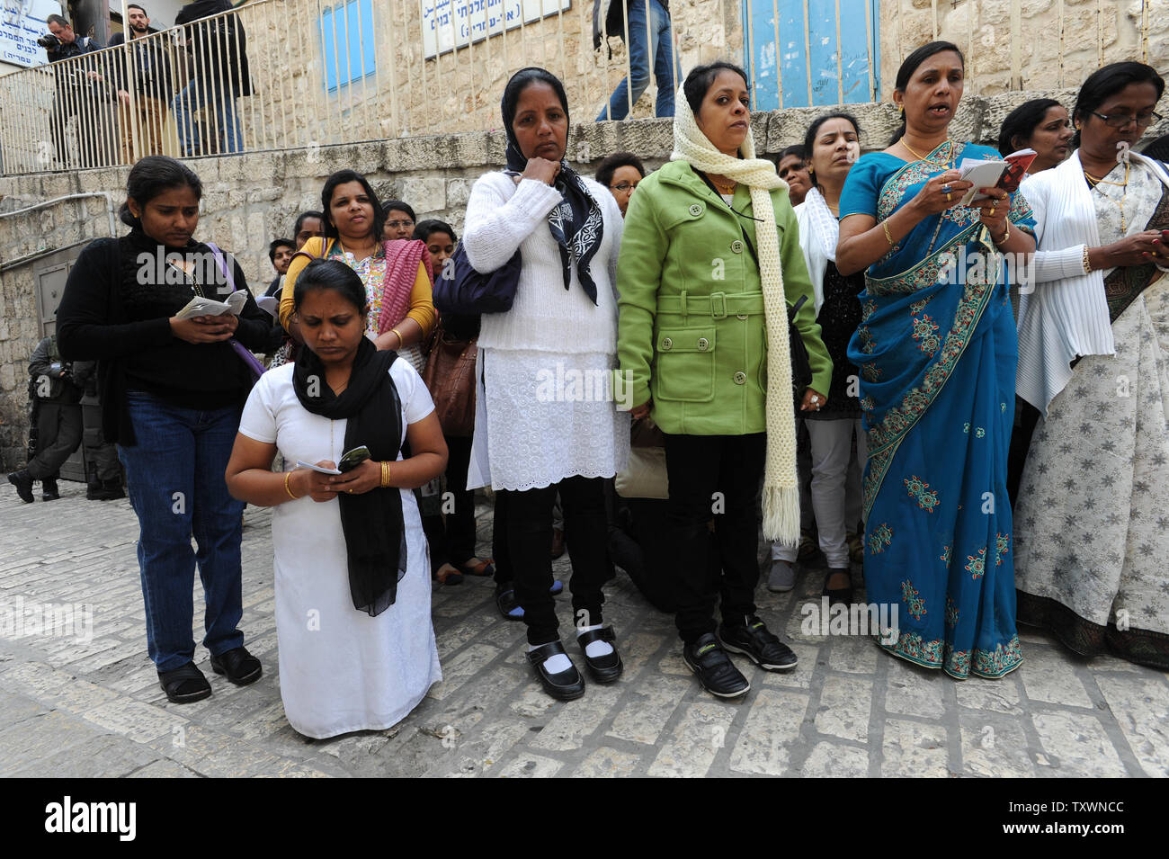 Christian pilgrims pray on Good Friday on the Via Dolorosa, the path ...